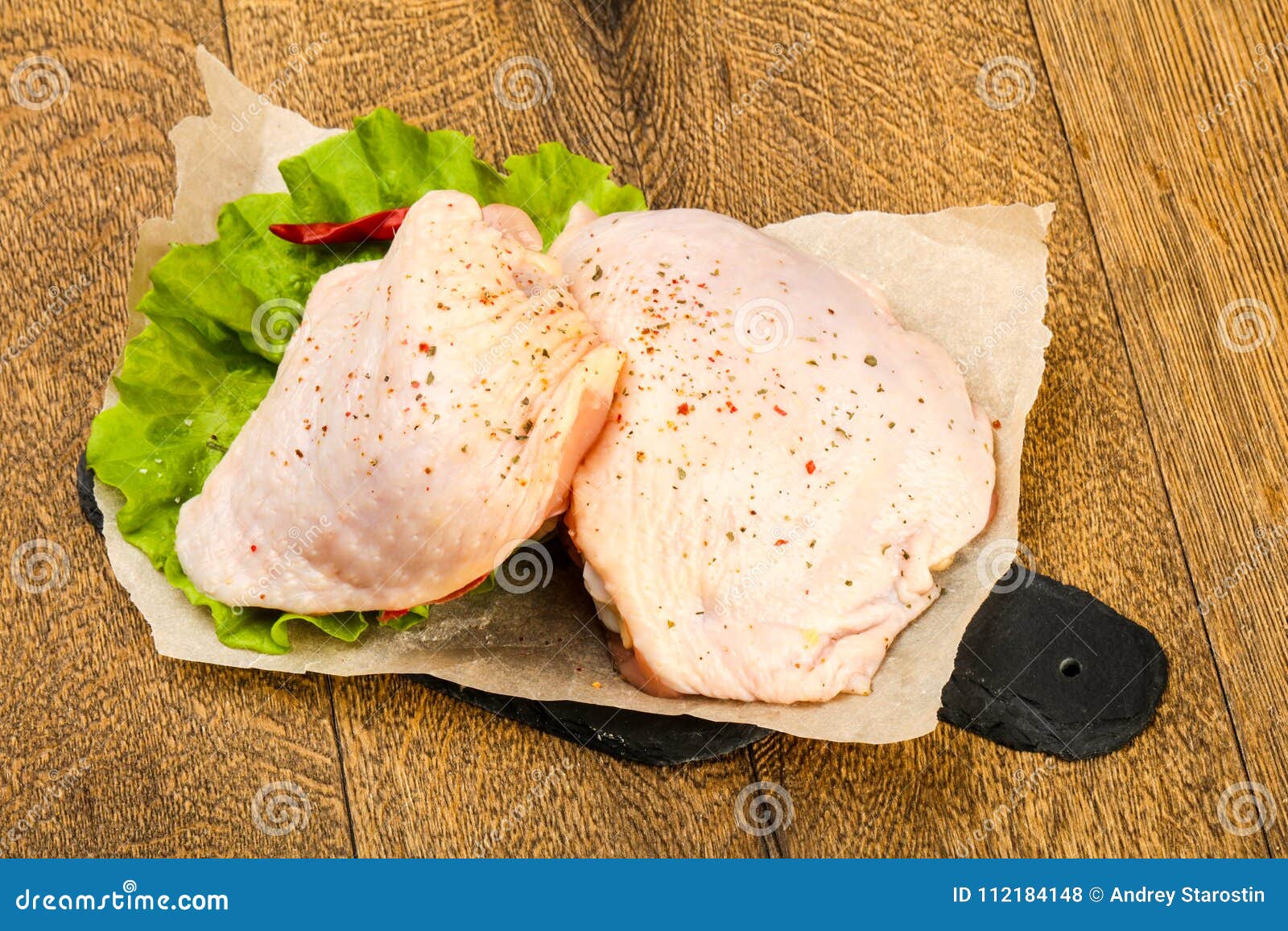 Raw chicken thigh stock photo. Image of cutting, wooden - 112184148