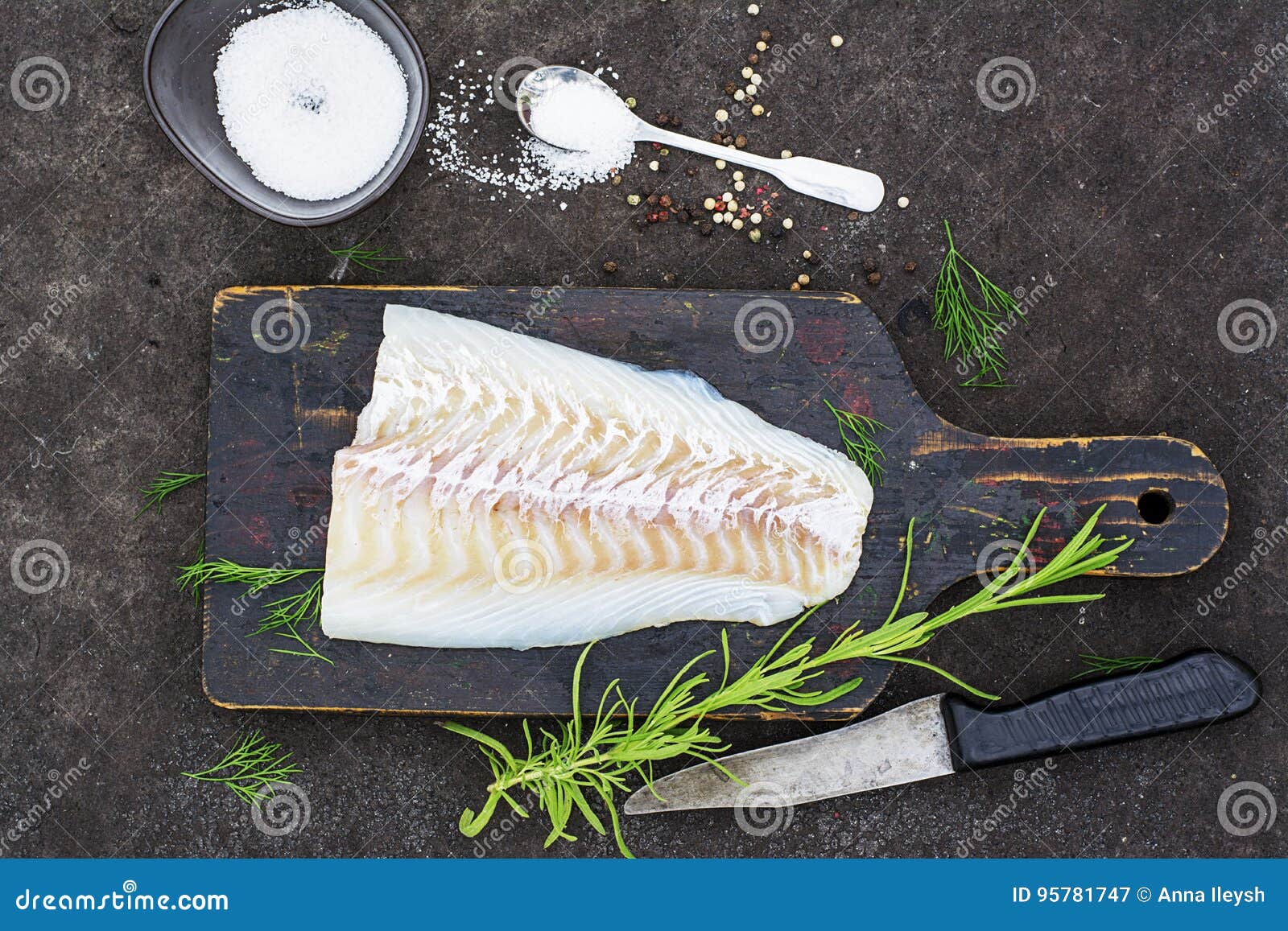 Raw Cod before Cooking on a Black Chopping Board with Herbs and Sea ...