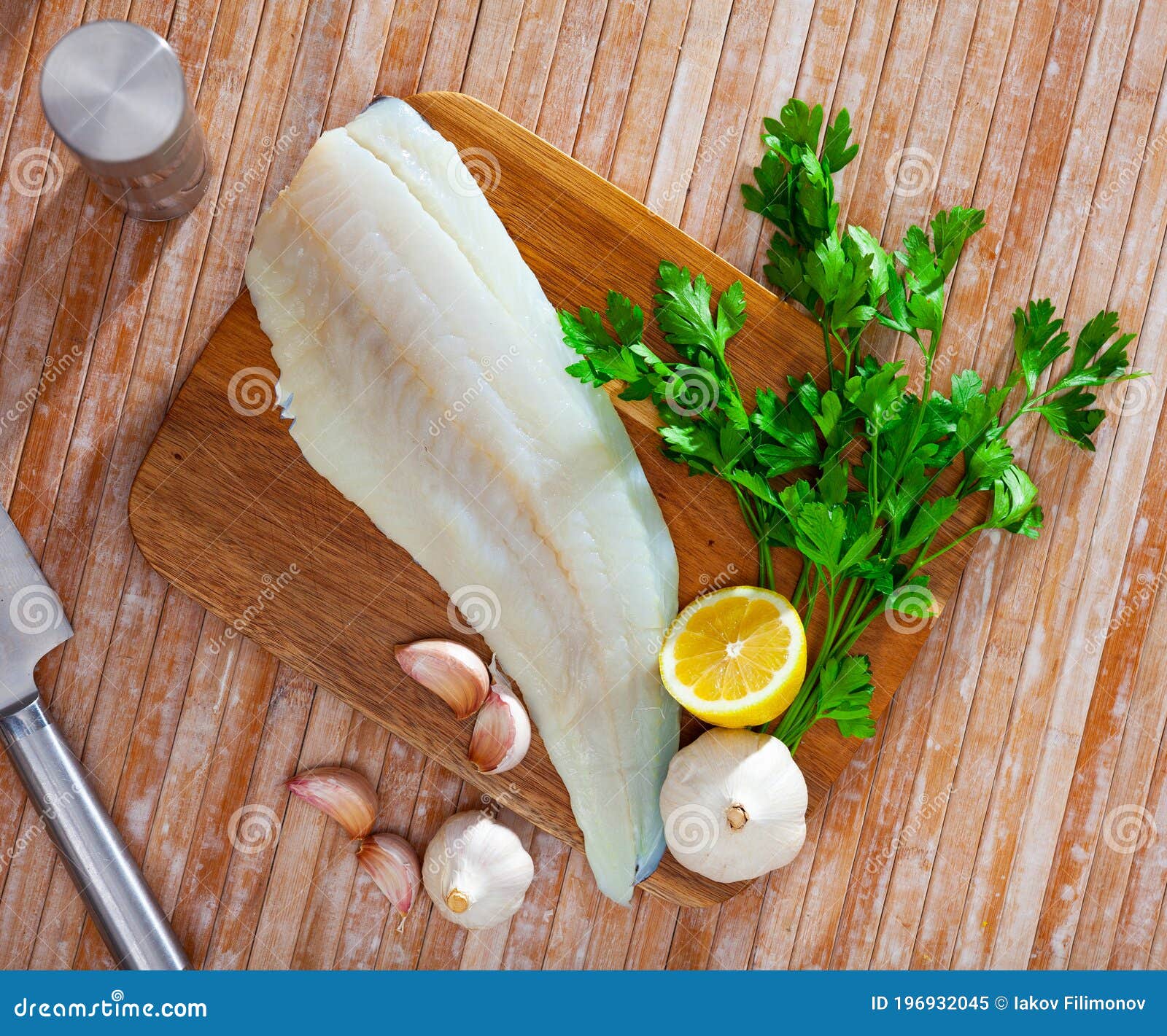 Raw Cod Fillet with Garlic and Lemon on Wooden Surface Stock Image ...