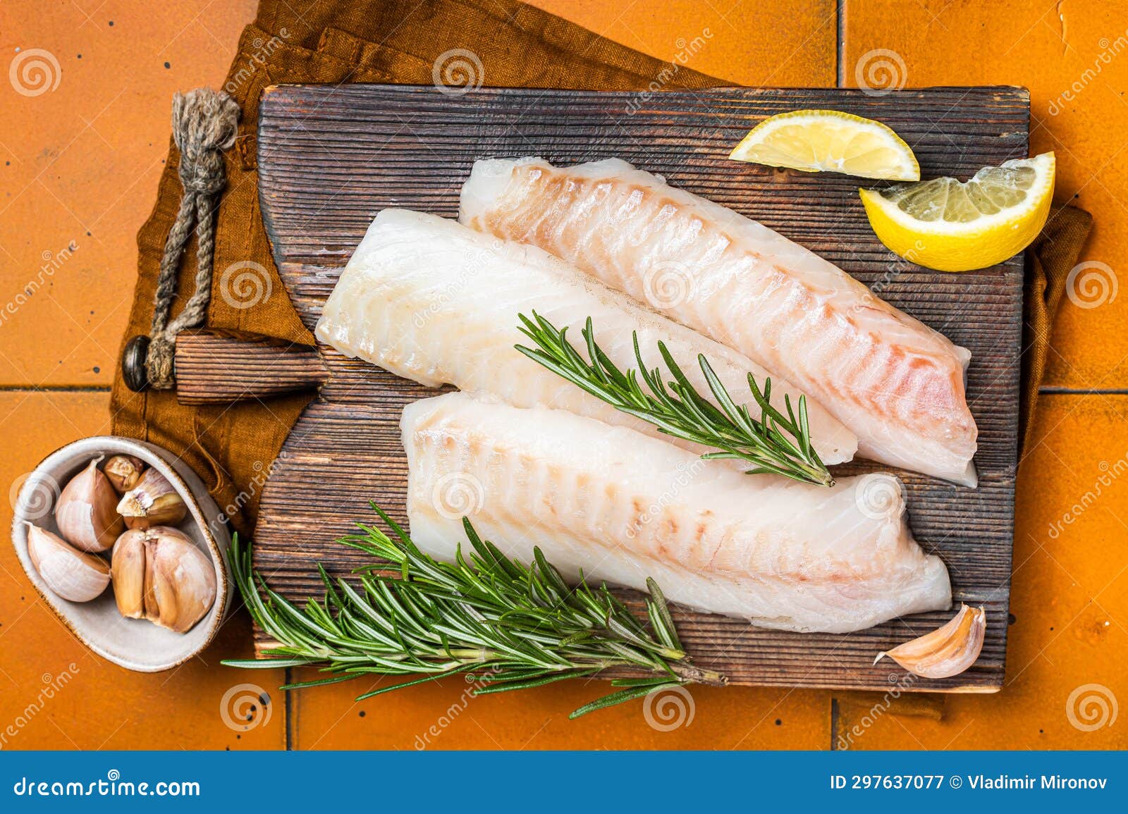 Raw Cod Fish Fillets, Codfish with Rosemary on Wooden Board. Orange ...