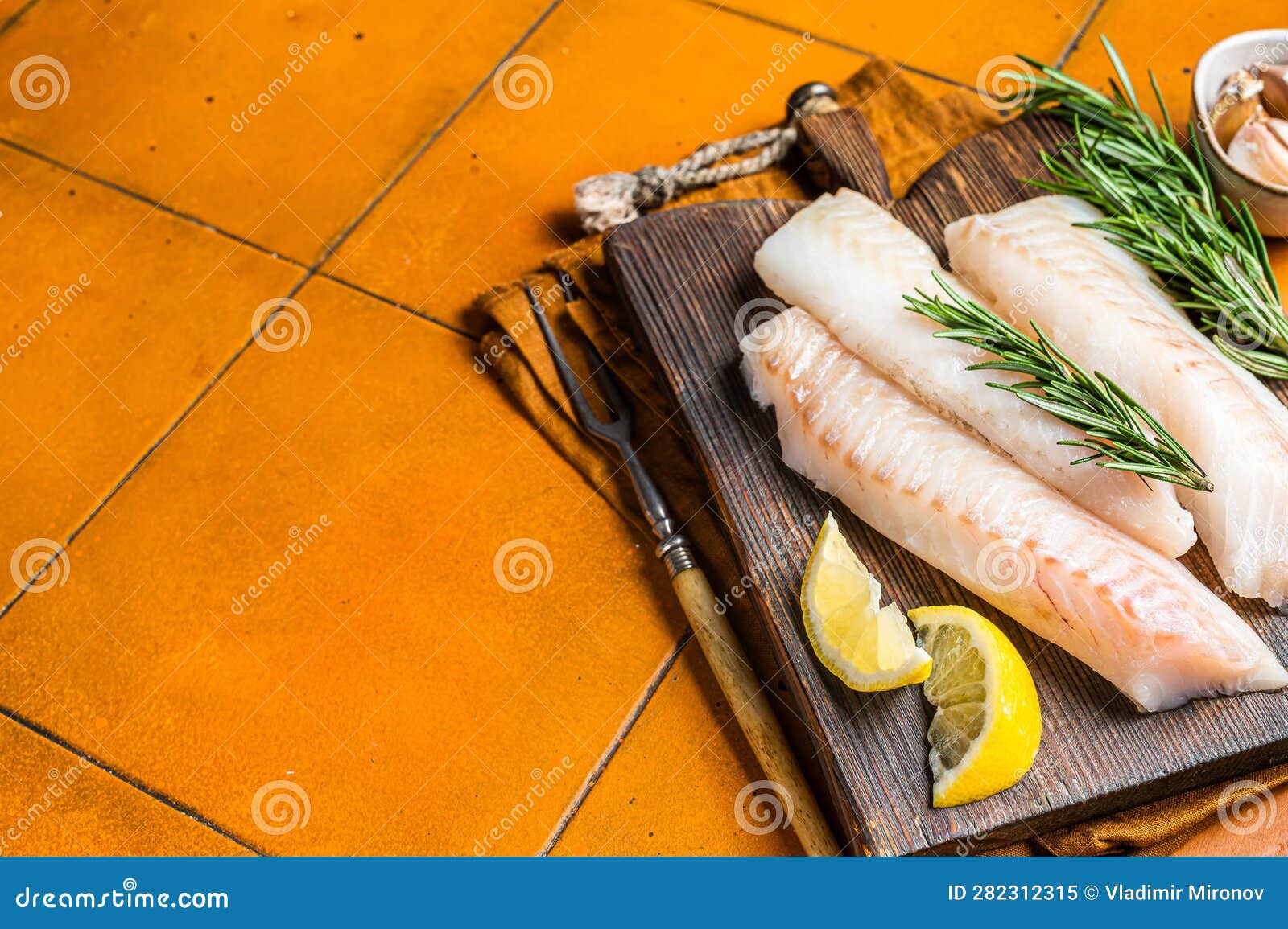Raw Cod Fish Fillets, Codfish with Rosemary on Wooden Board. Orange ...