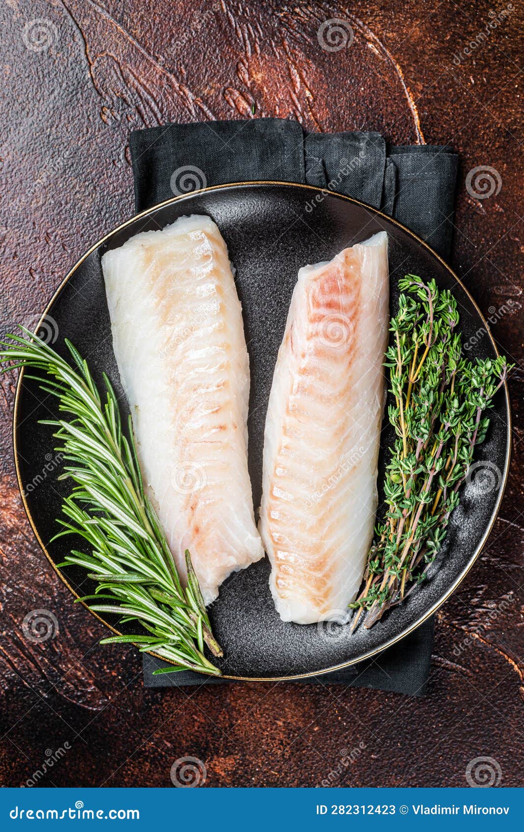 Raw Cod Loin Fillet Steaks with Herbs on Plate. Dark Background Stock ...