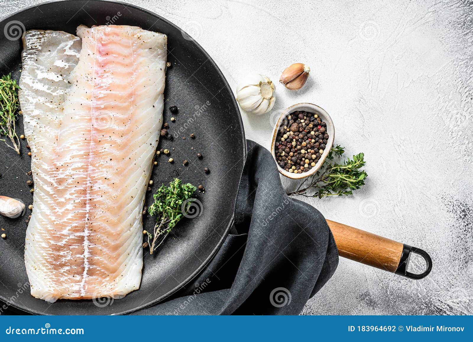 Raw Cod Loin with Herbs in a Frying Pan. Gray Background. Top View ...