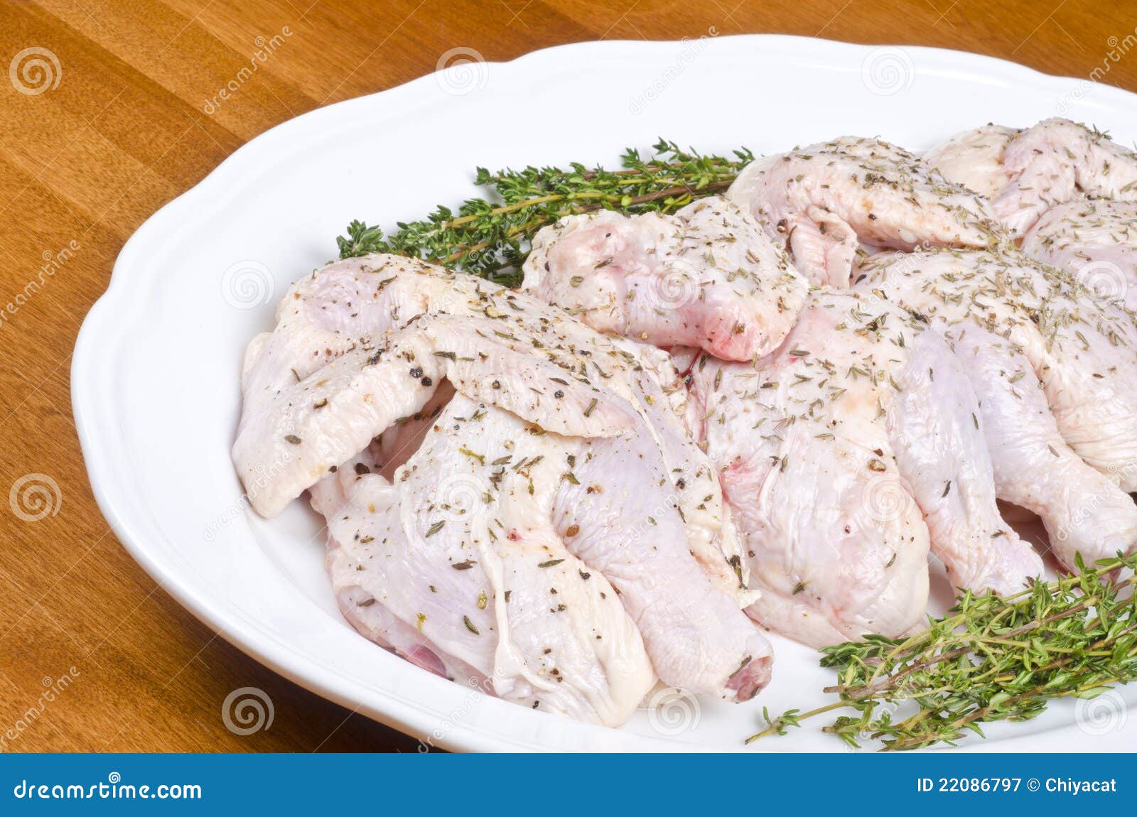 Raw Cornish Game Hen on a White Plate Stock Image - Image of green ...