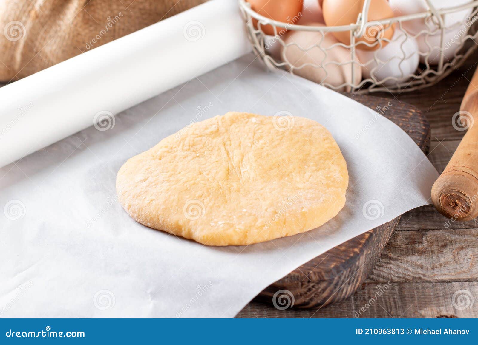 Raw Dough on a Cutting Board on a Rustic Wooden Table. Frozen Dough ...