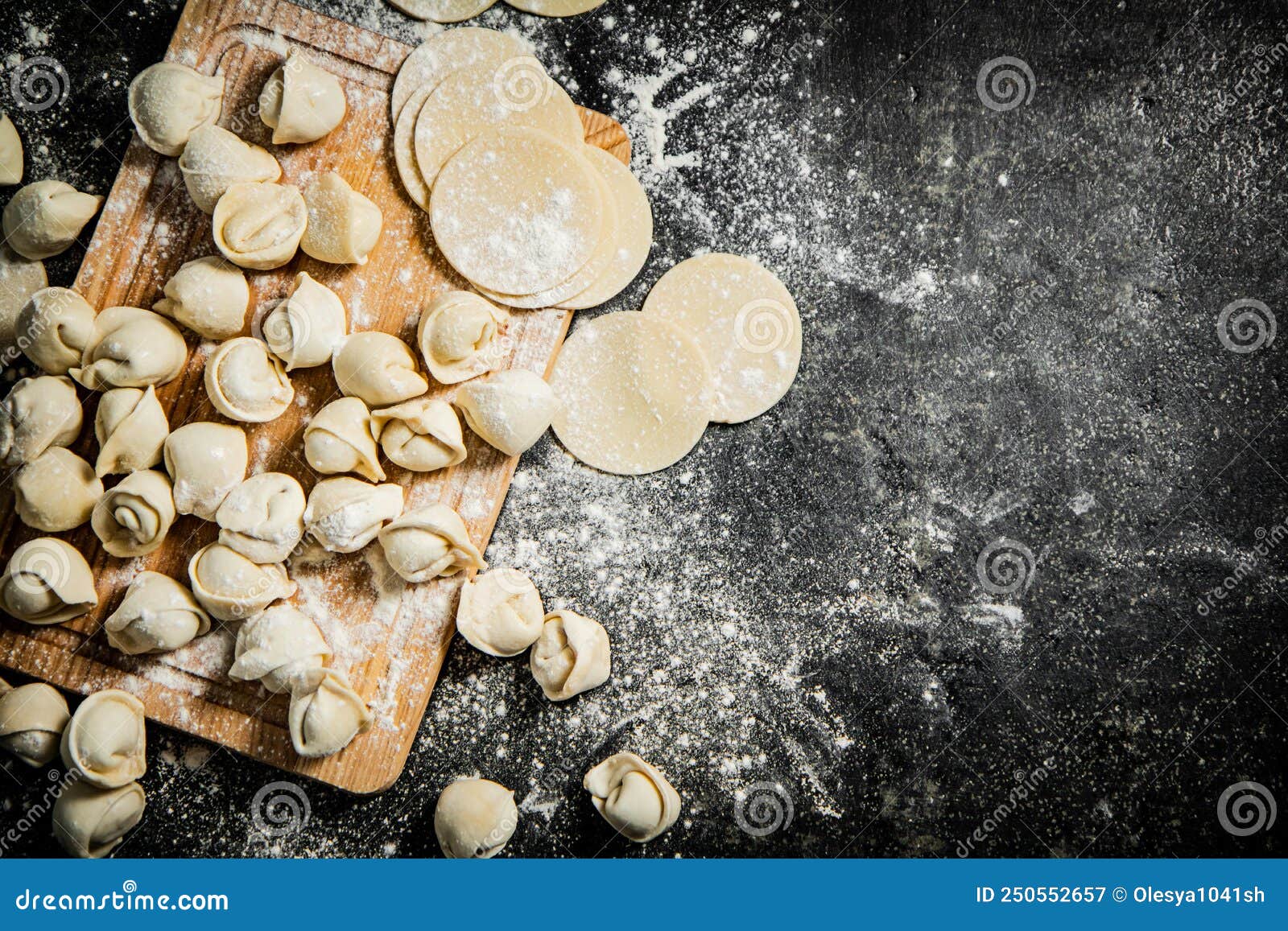 Raw Dumplings and Round Pieces of Dough on a Cutting Board. Stock Image ...