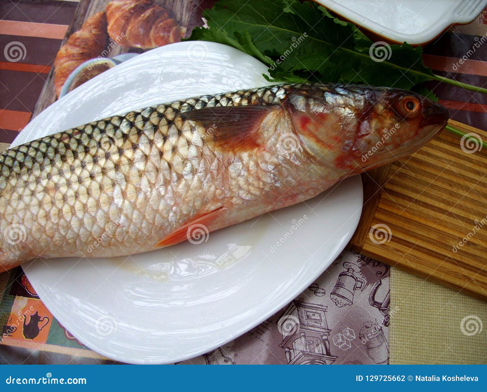 Raw fish on a plate stock photo. Image of wood, cold - 129725662