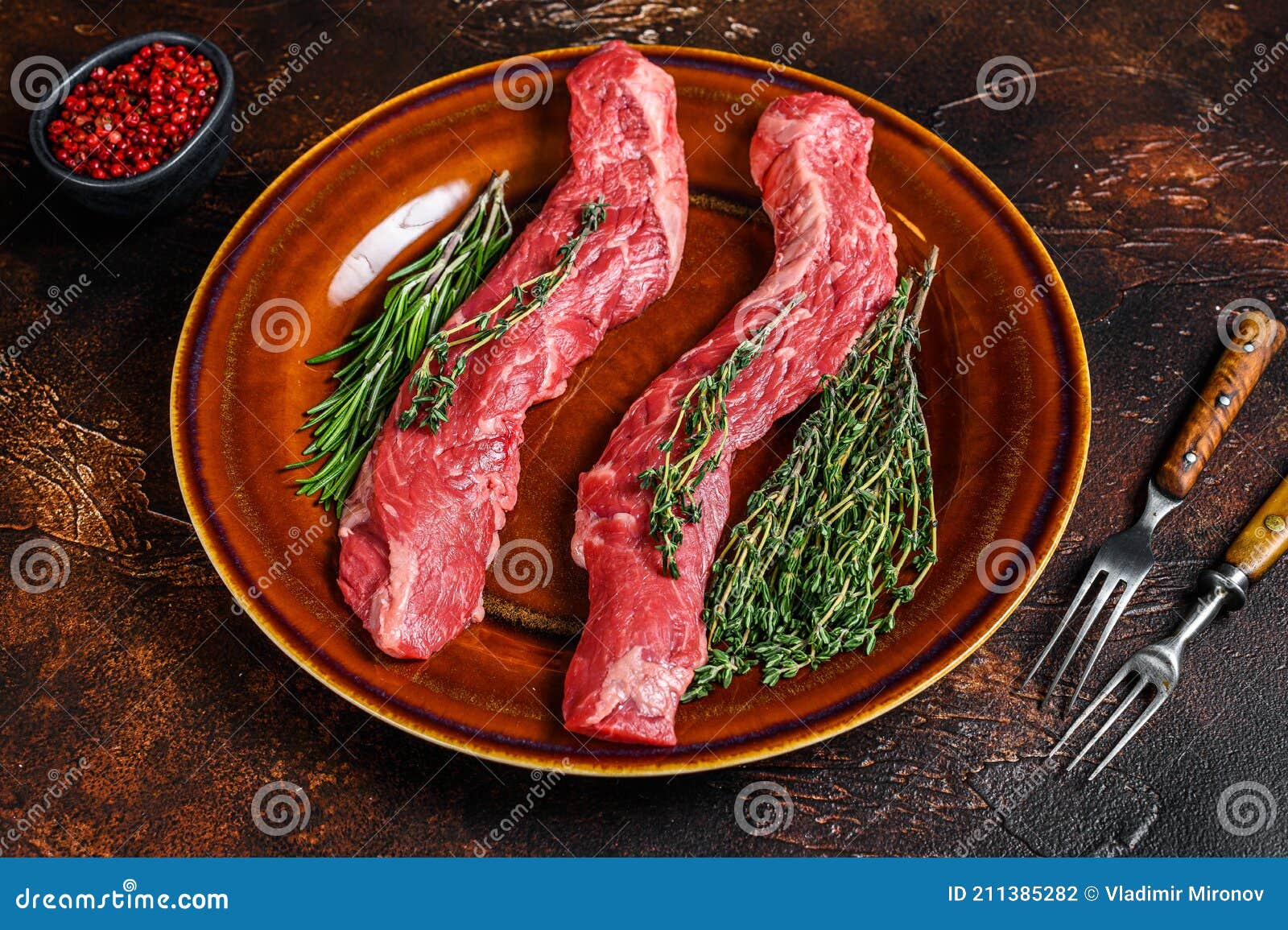 Raw Flank Beef Meat Steak on a Plate. Dark Background Stock Photo ...