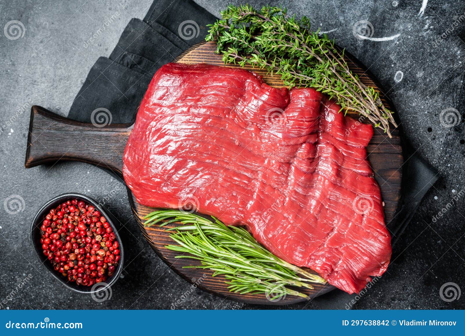 Raw Flank Beef Steak, Uncooked Meat with Herbs. Black Background Stock ...