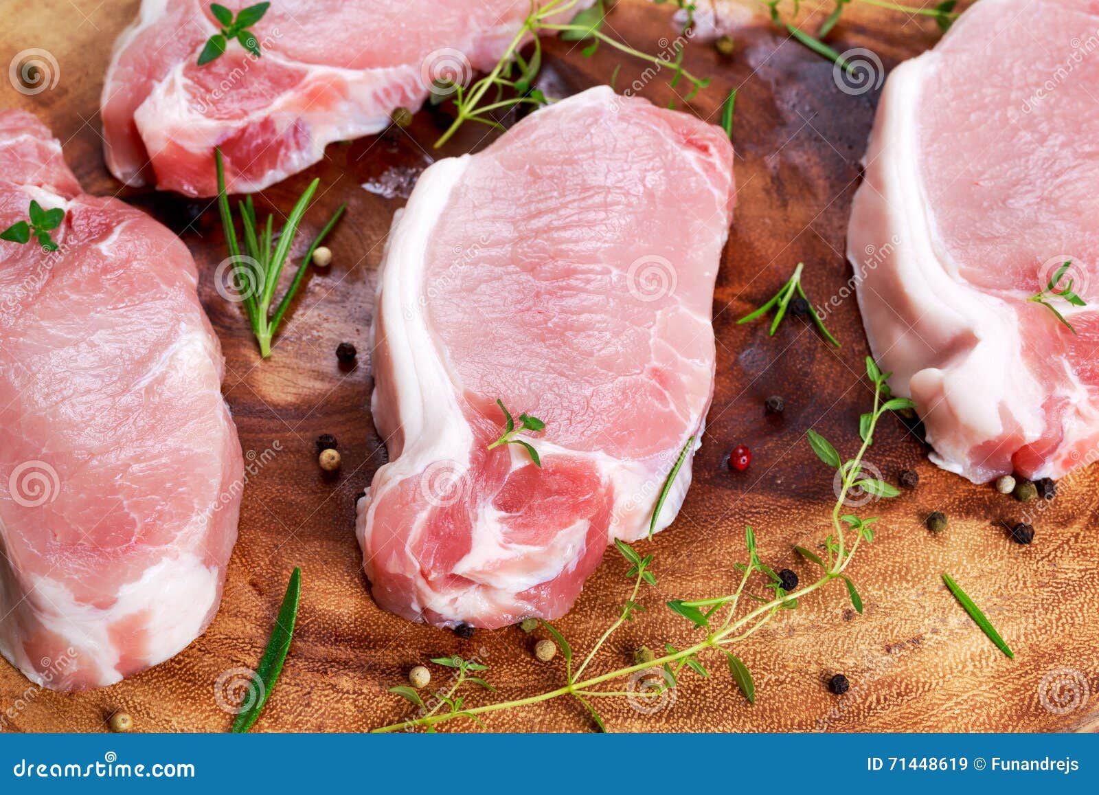 Raw Fresh Boneless Pork Chops with Herbs. on Wooden Board Stock Image ...
