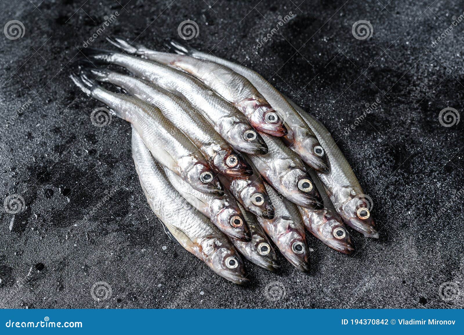 Raw Fresh Capelin Fish. Black Background Stock Photo - Image of salty ...