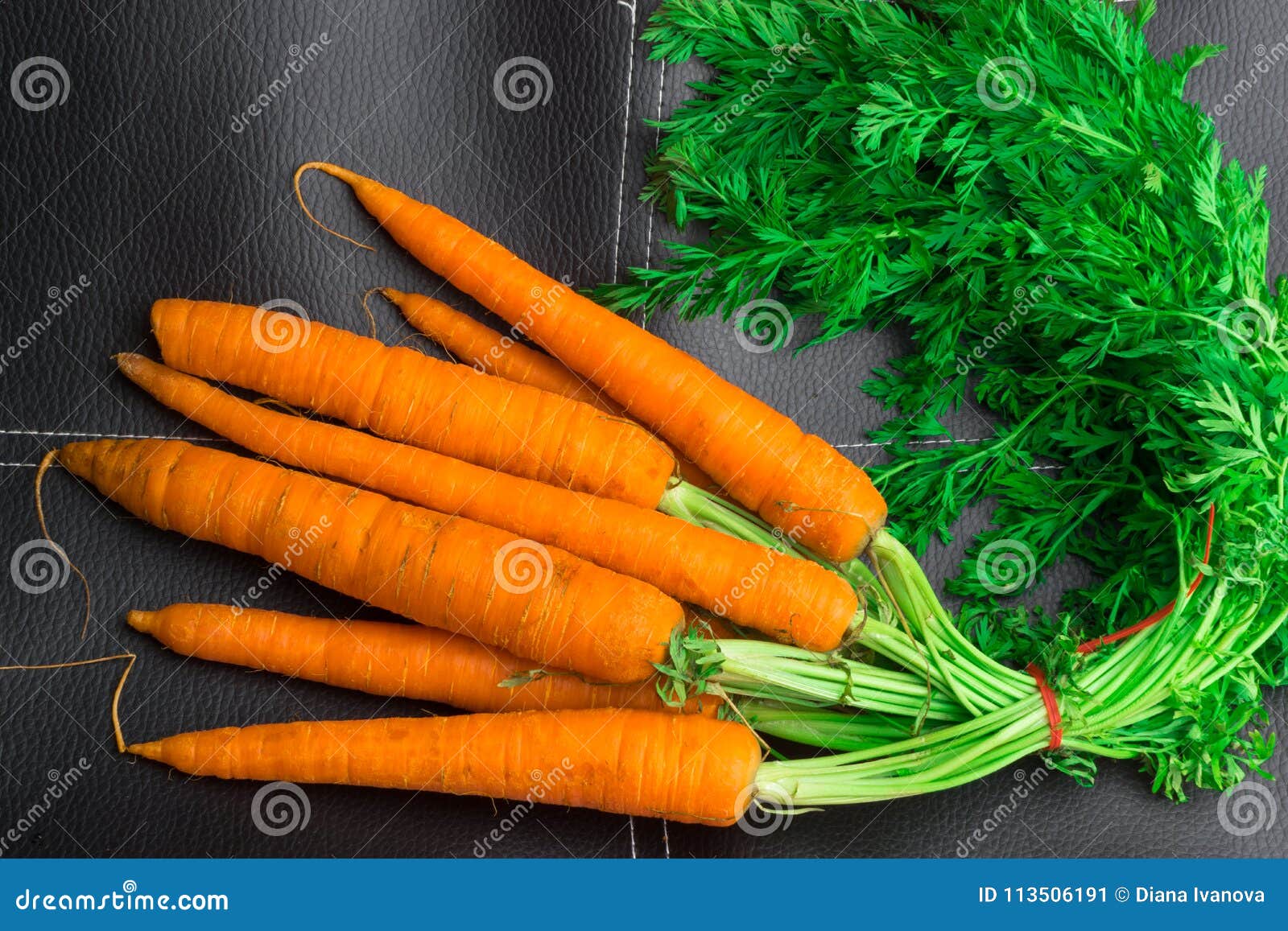 Raw Organic Carrot Bunch on Black Table Stock Image - Image of black ...