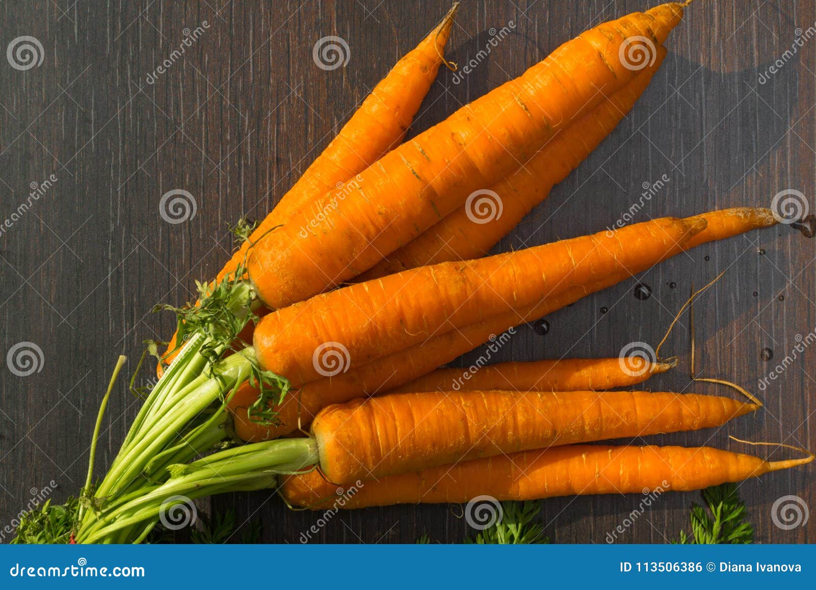 Raw Organic Carrot Bunch on Black Table Stock Photo - Image of board ...