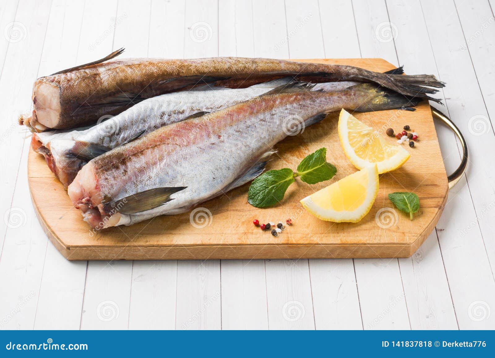 Raw Fresh Pollock Fish on a Wooden Board with Lemon Stock Photo - Image ...