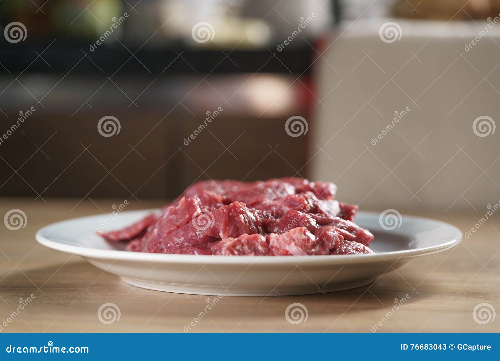 Raw Fresh Sliced Beef for Beefsteaks in Plate on Kitchen Table Stock ...