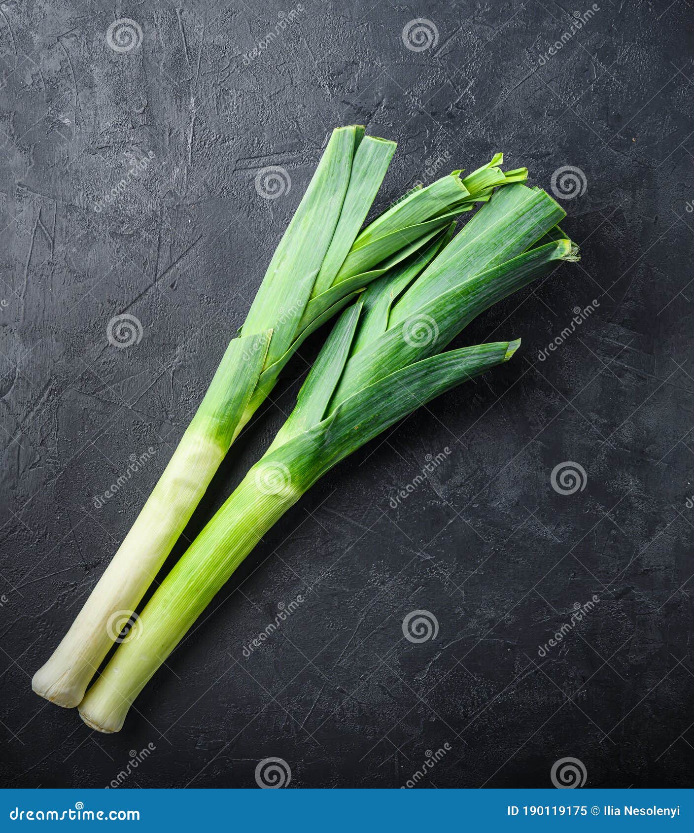 Raw Green Organic Leeks on Black Textured Background, Top View Stock ...