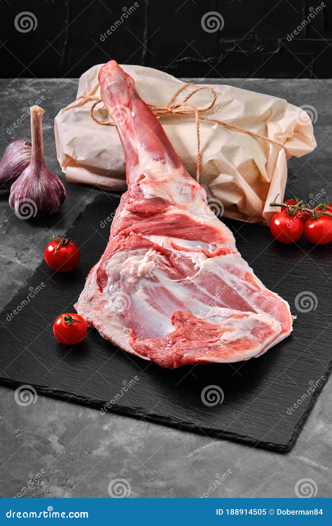 Raw Lamb Leg on Marble Cutting Board. Dark Background. Side View. Stock ...