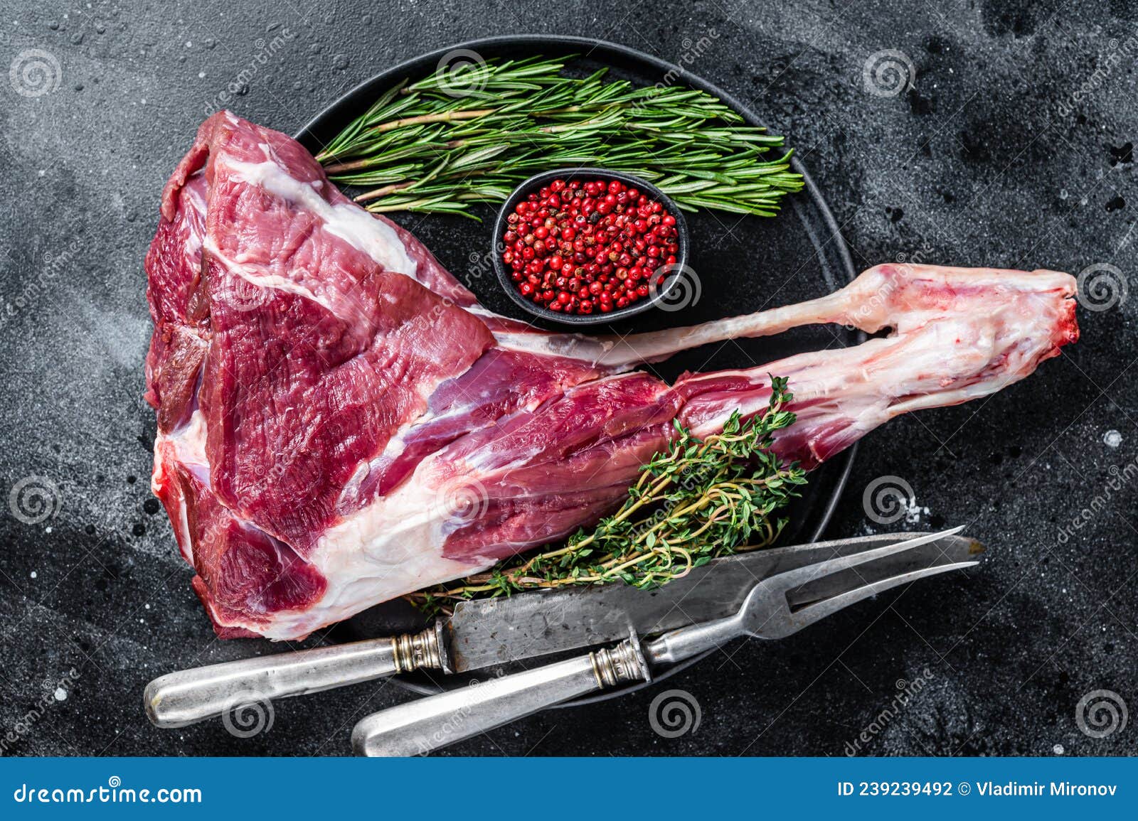 Raw Lamb Mutton Leg Meat on the Bone with Herbs. Black Background Stock ...