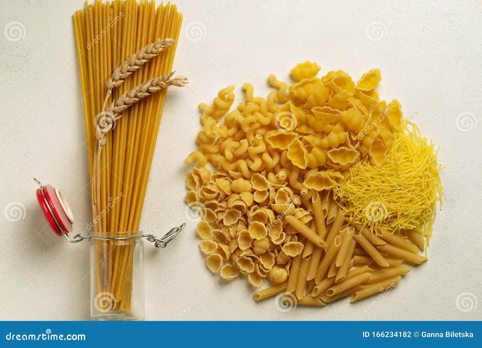 Raw Long Pasta in a Glass Jar with Spikelets and Several Types of Curly ...