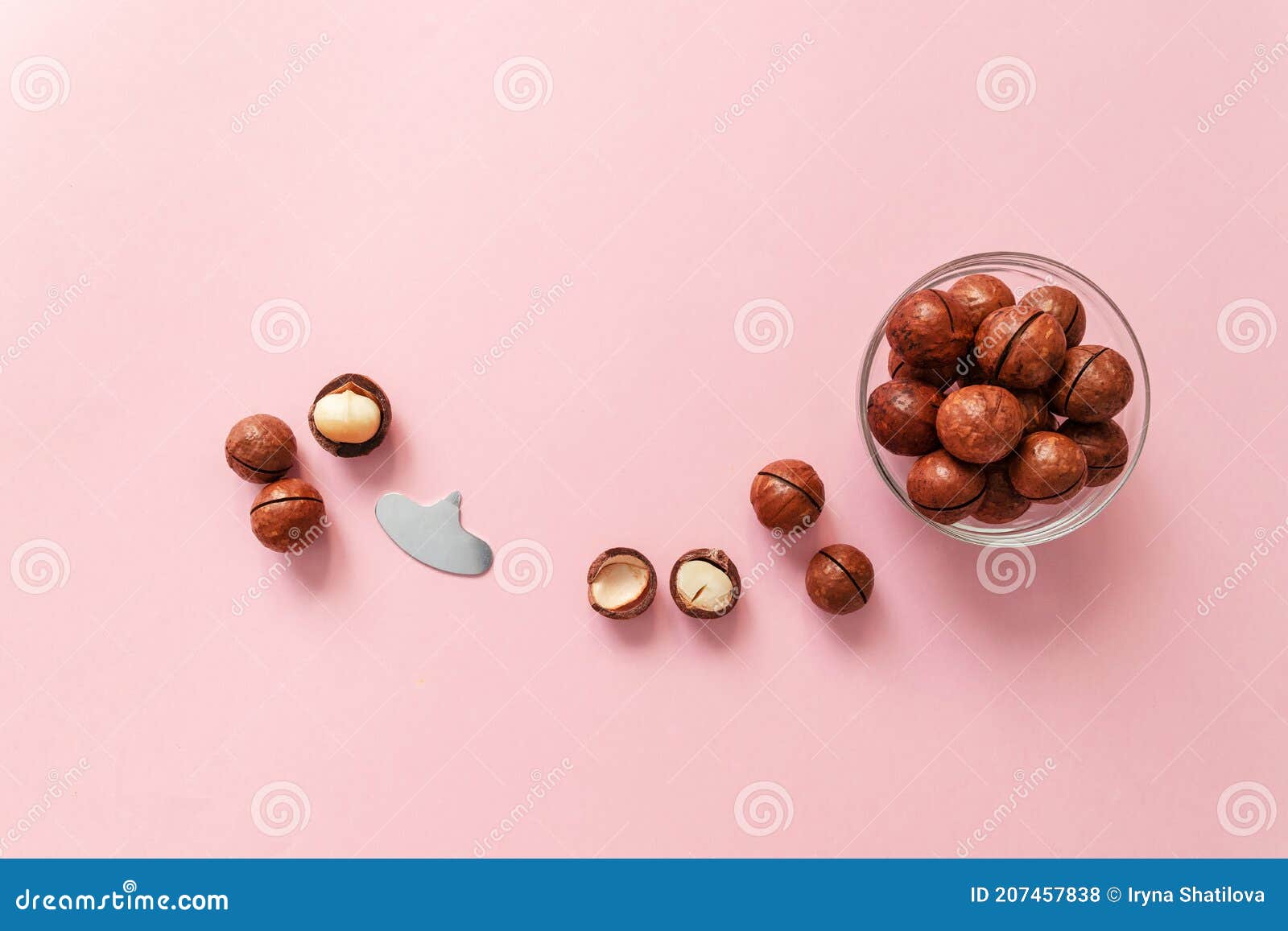 Raw Macadamia Nuts in a Transparent Glass Bowl and Scattered on a Pink ...