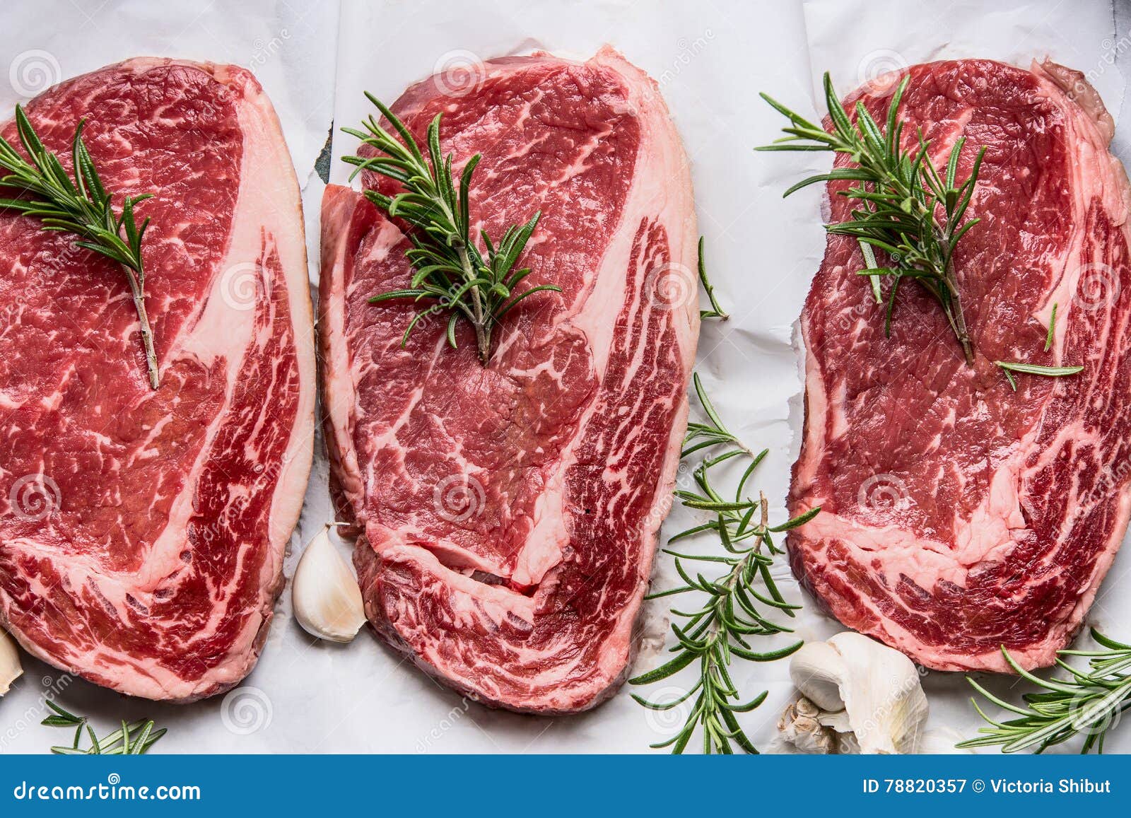 Raw Marbled Meat Steaks on White Paper , Top View Stock Image - Image ...