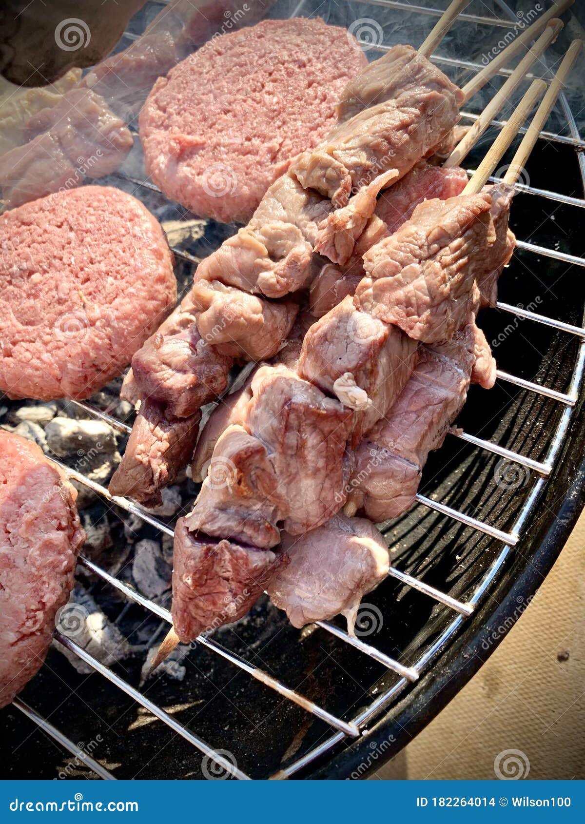 Raw Meat Cooking Over a Bbq Stock Photo - Image of coals, burger: 182264014