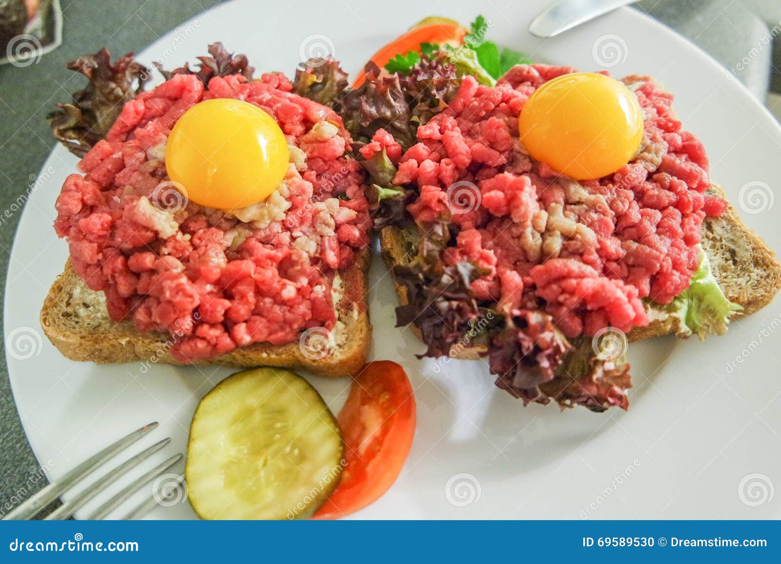 Raw meat with egg on bread stock photo. Image of nutrition - 69589530