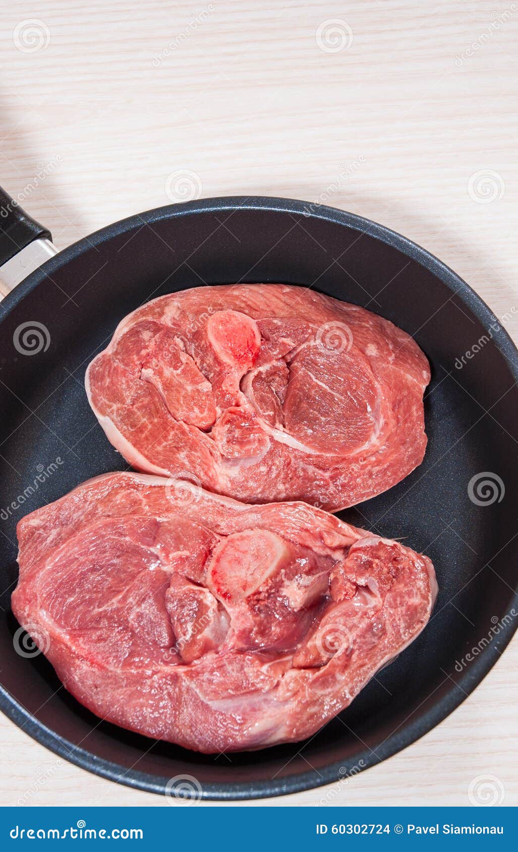 Raw meat in a frying pan stock photo. Image of cuisine - 60302724