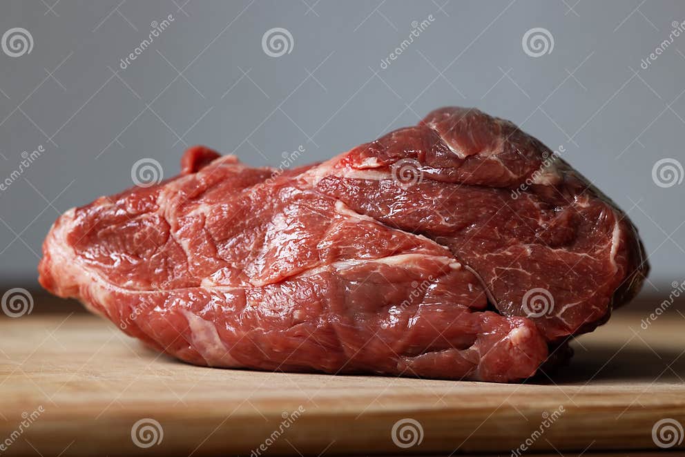Raw Meat. a Large Piece of Beef on Cutting Board Stock Photo - Image of ...