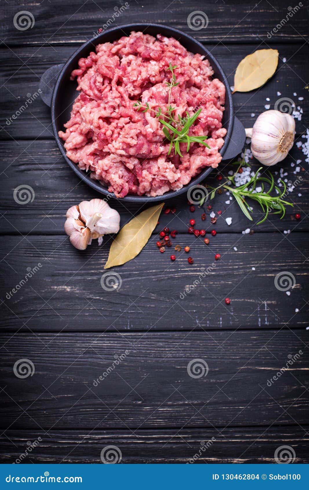 Raw Minced Meat in Bowl with Ingredients for Cooking on Black Stock ...