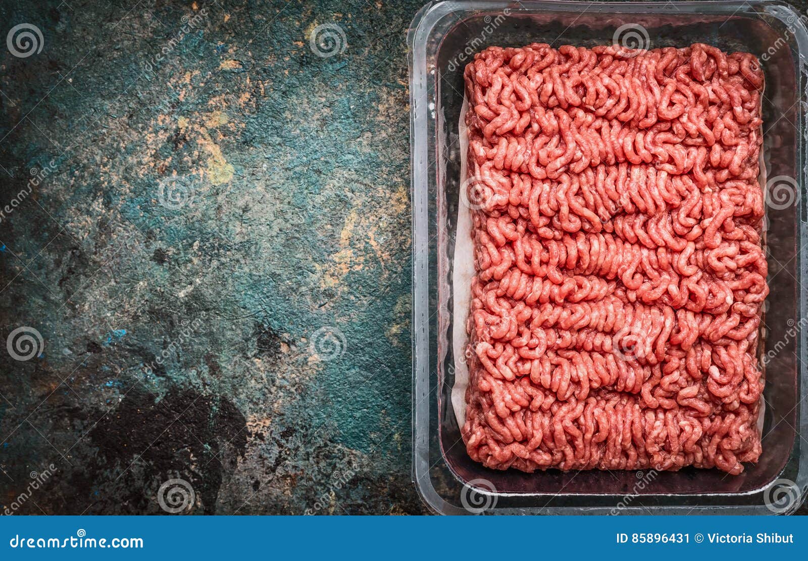 Raw Minced Meat in Plastic Box on Rustic Background, Top View Stock ...
