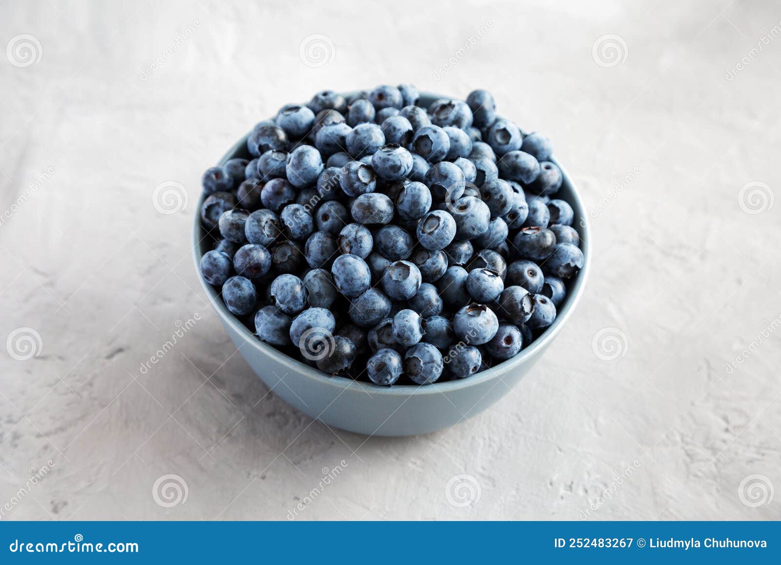 Raw Organic Blueberries in a Bowl on a Gray Background, Side View Stock ...