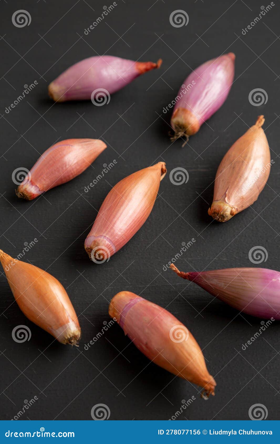 Raw Organic Shallots on a Black Surface, Side View Stock Photo - Image ...
