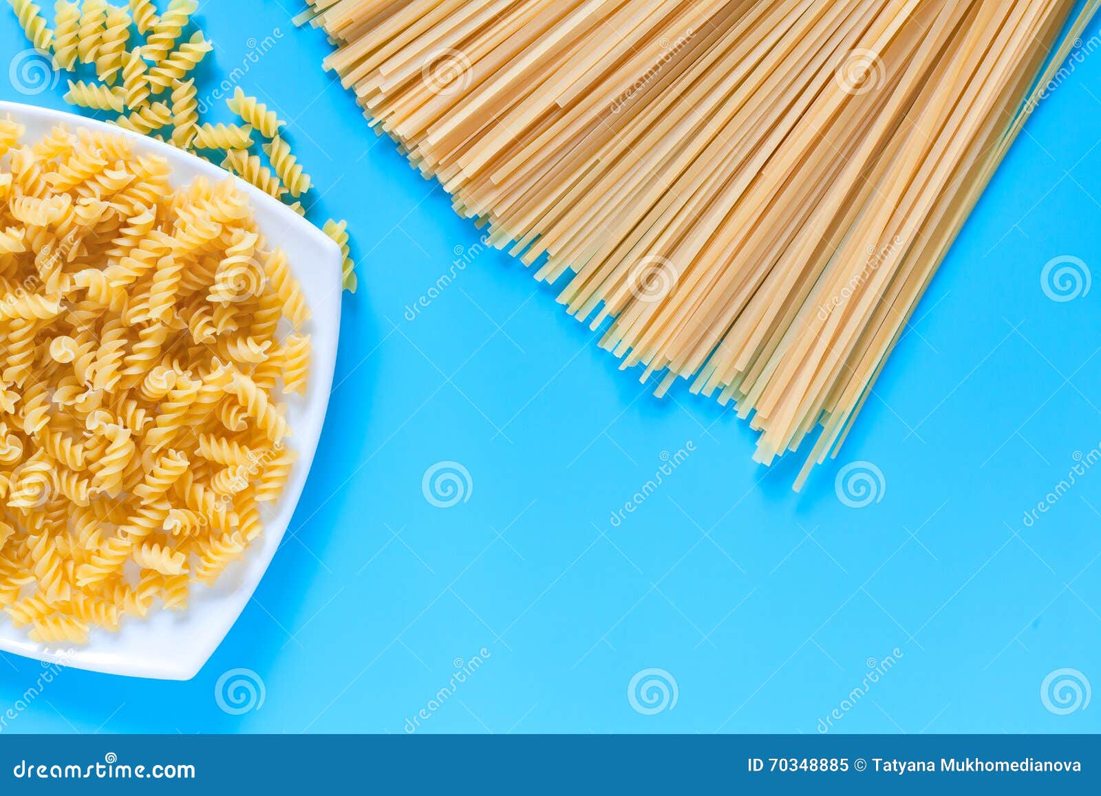 Raw Pasta on a Blue Background with Copy Space. Stock Image - Image of ...