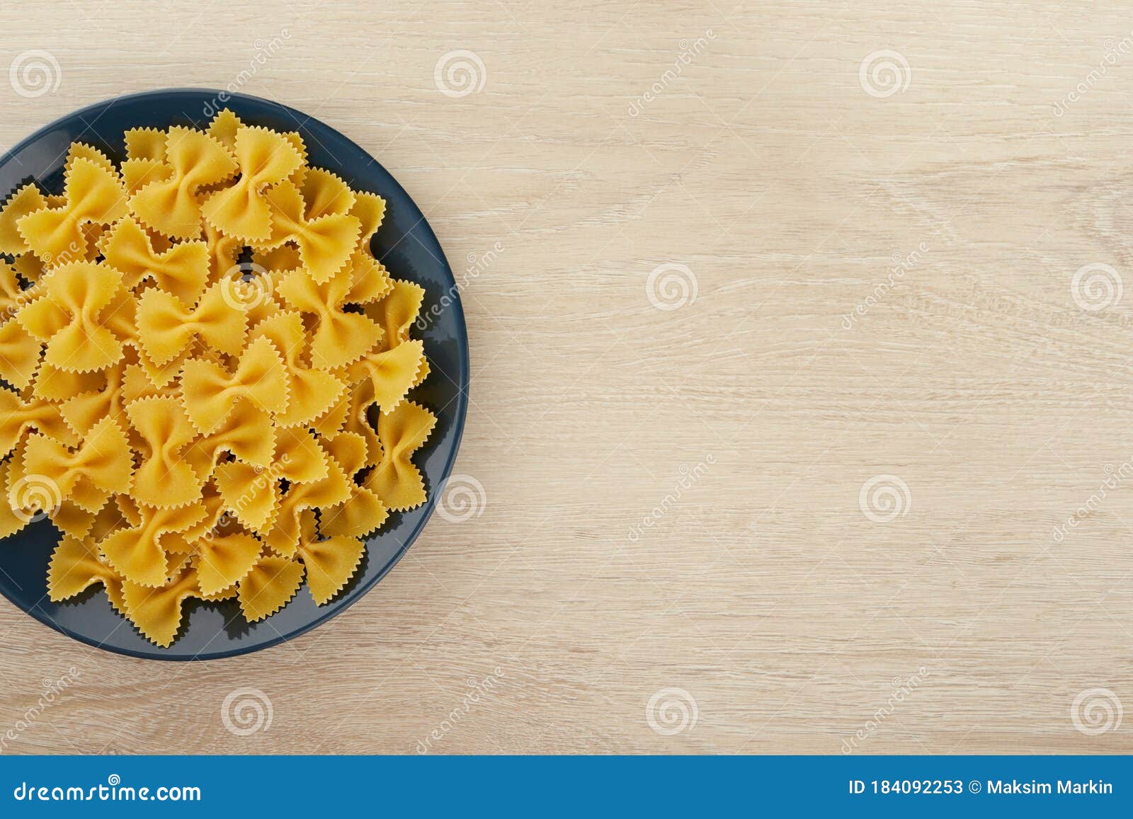 Raw Pasta in the Shape of a Bow on a Plate, Top View, Copy Space Stock ...