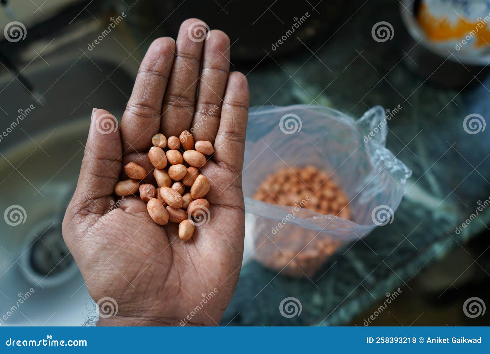 Raw peanuts in the hand stock photo. Image of market - 258393218