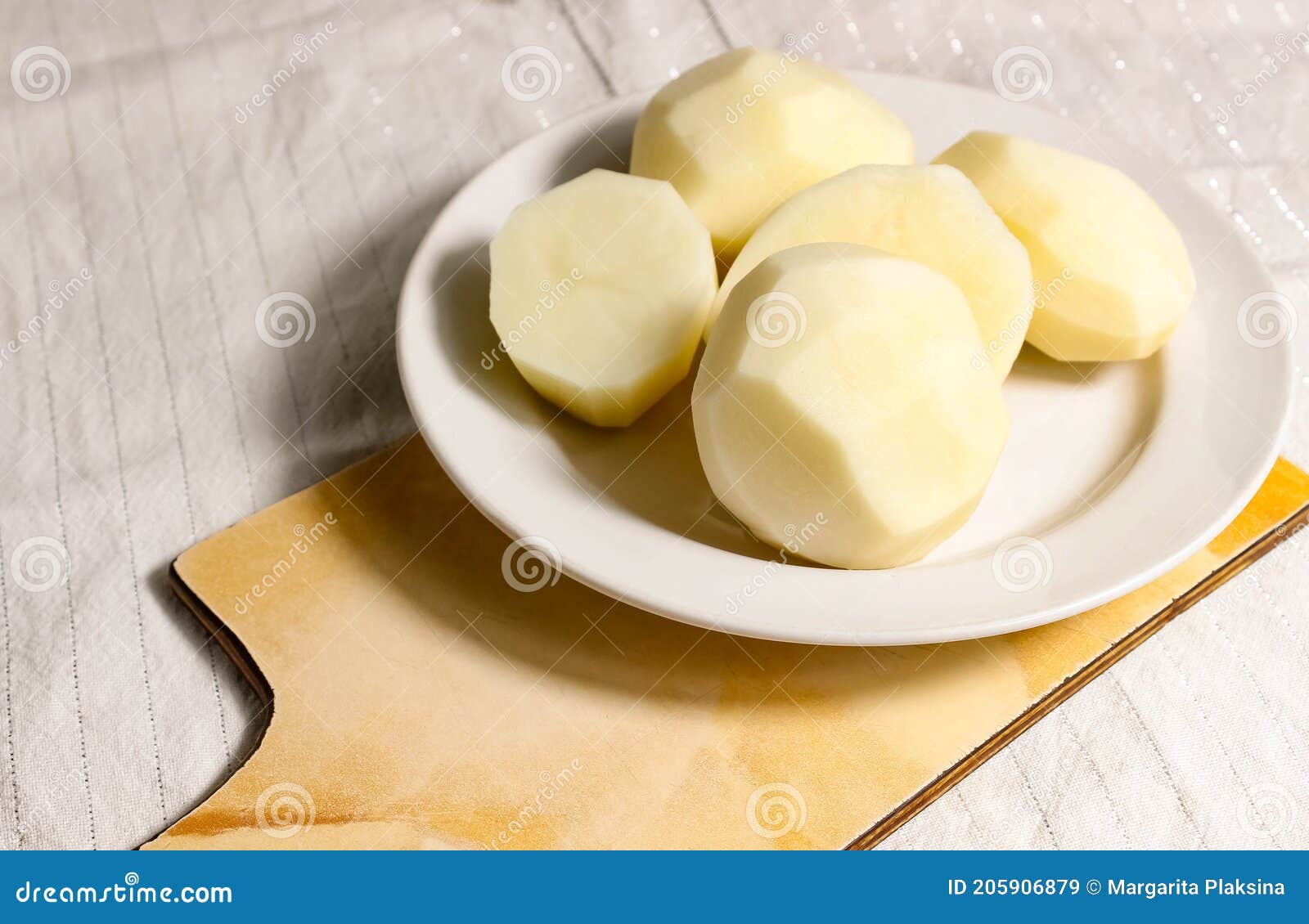 Raw Peeled Potatoes on a Plate and Cutting Board Stock Image - Image of ...
