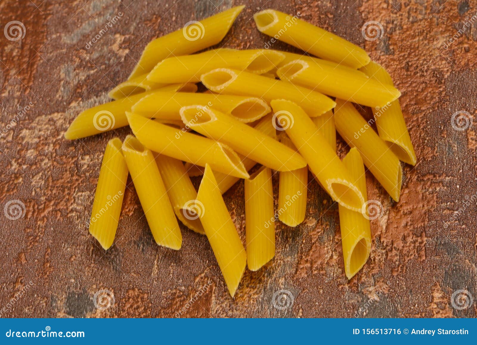 Raw penne pasta for bowl stock photo. Image of carbohydrate - 156513716
