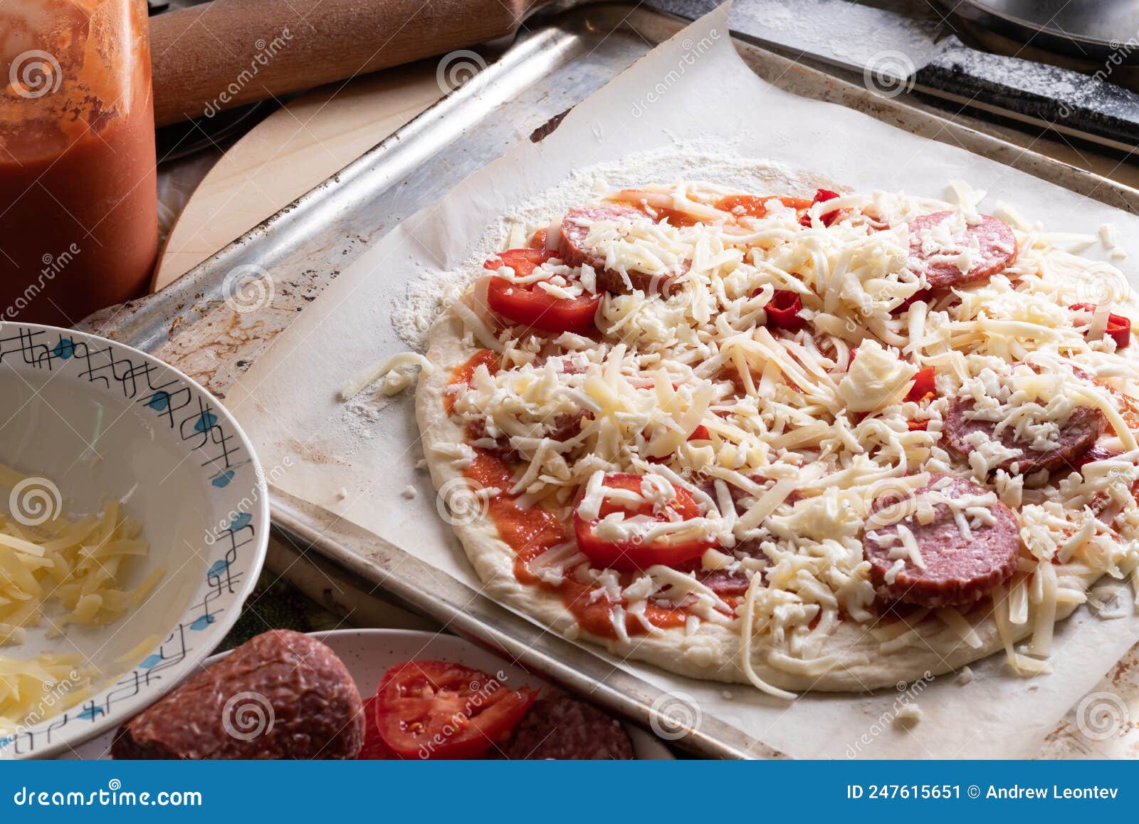 Raw Pizza, Preparation in Traditional Style. Adding Cheese on a Pizza ...