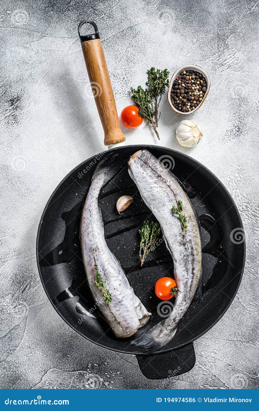 Raw Pollock Fish in a Pan. Organic Seafood. Gray Background Stock Photo ...