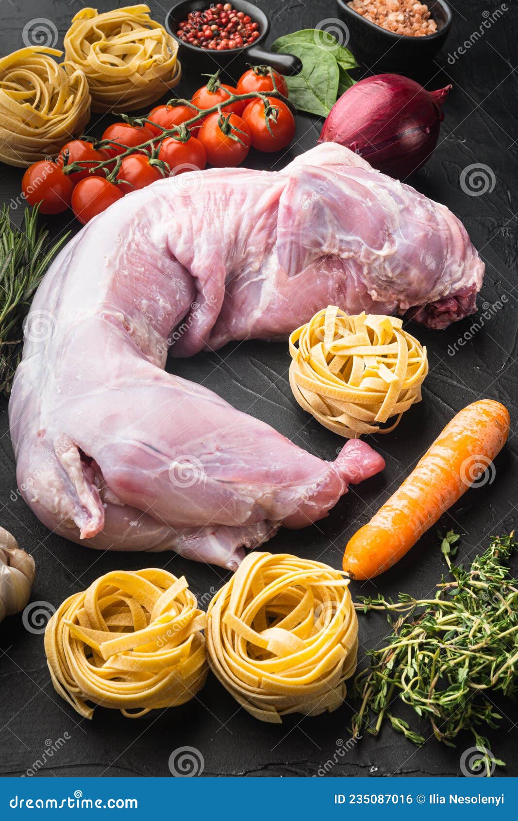 Raw Rabbit Meat with Fresh Vegetables Ready for Cooking, on Black Stone ...