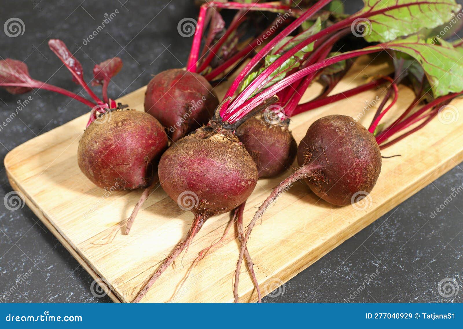 Raw Beet with Root, Stem and Green Leaves on Wooden Board Stock Image ...