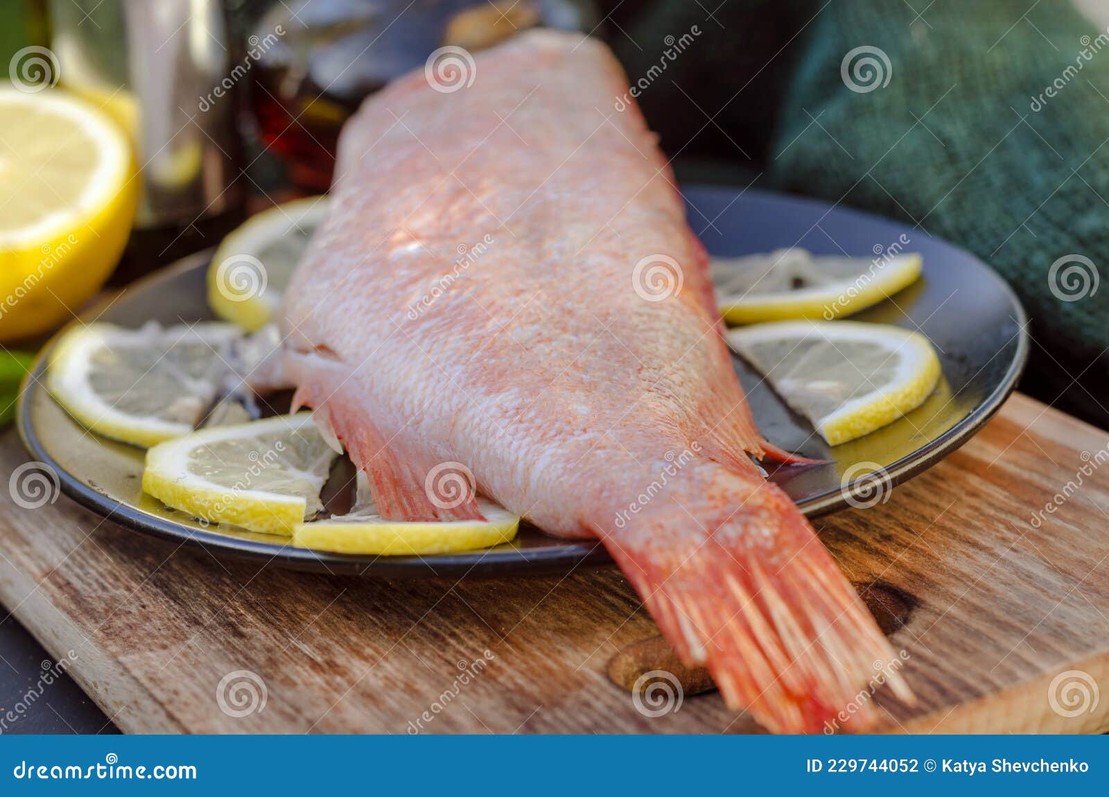 Raw Red Snapper on a Plate with Lemon Stock Photo - Image of rosemary ...