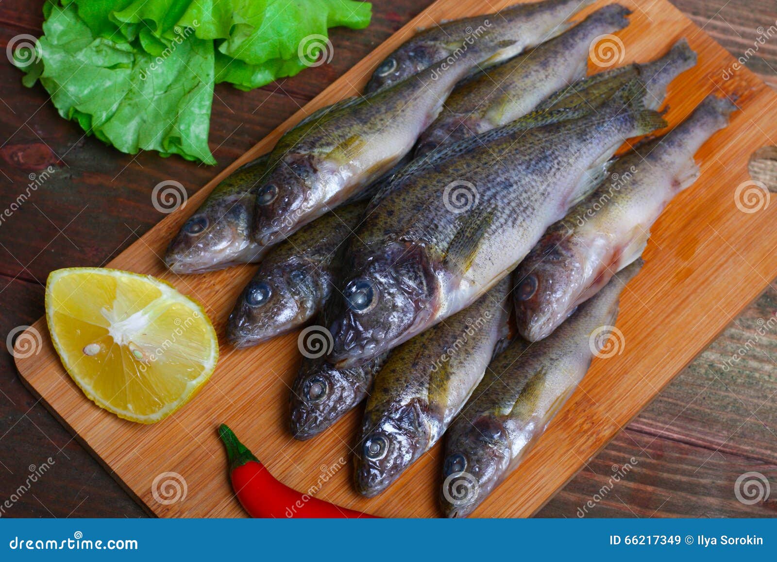Raw Redfish Ruff Fish on the Kitchen Table with Vegetables and Lemon ...