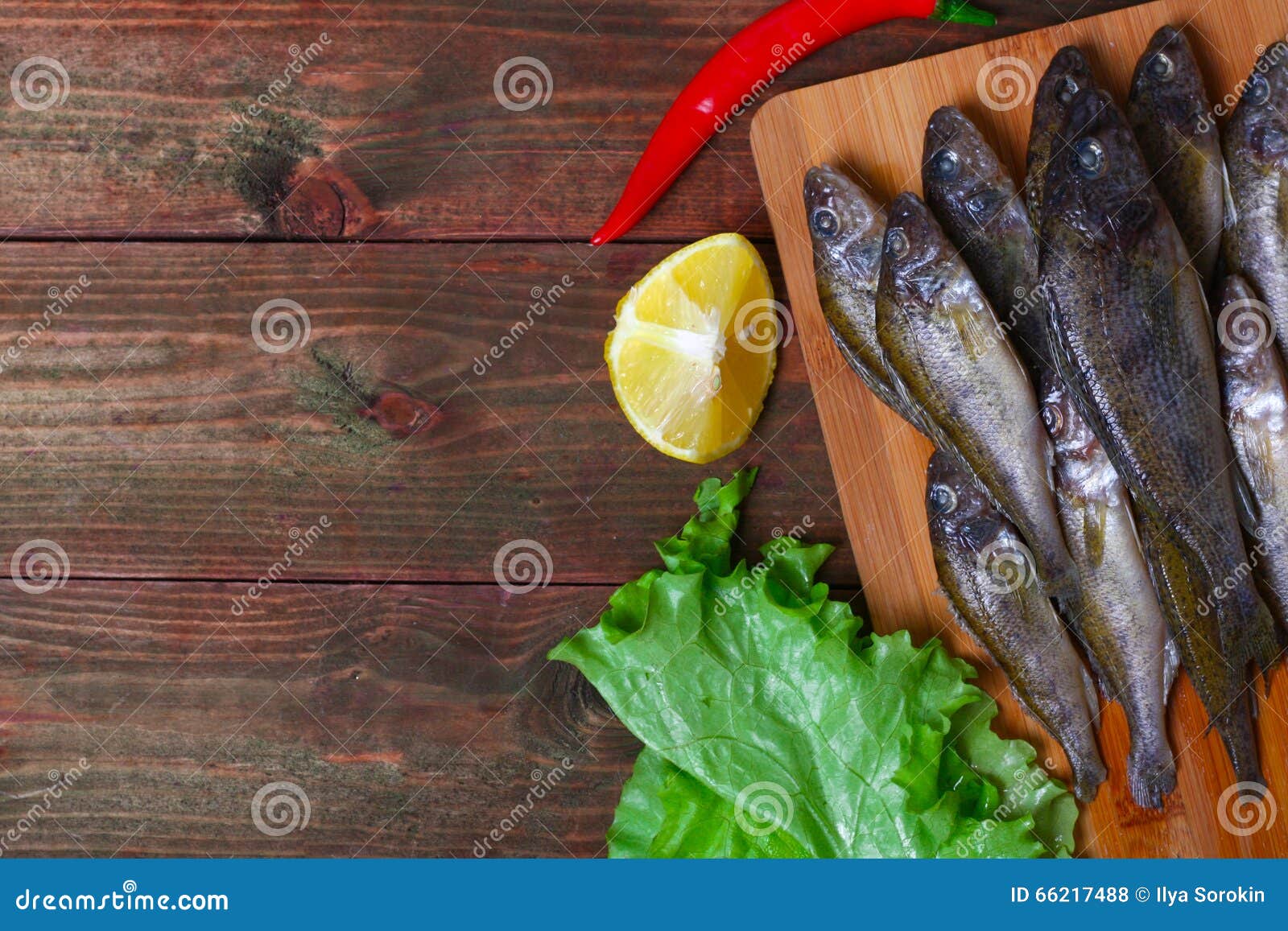 Raw Redfish Ruff Fish on the Kitchen Table with Vegetables and Lemon ...