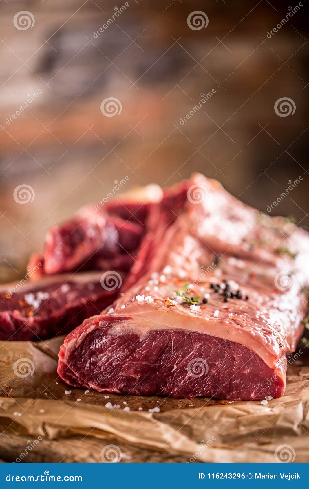 Raw Rib Eye Beef Steak with Salt Spices and Herbs Stock Photo - Image ...