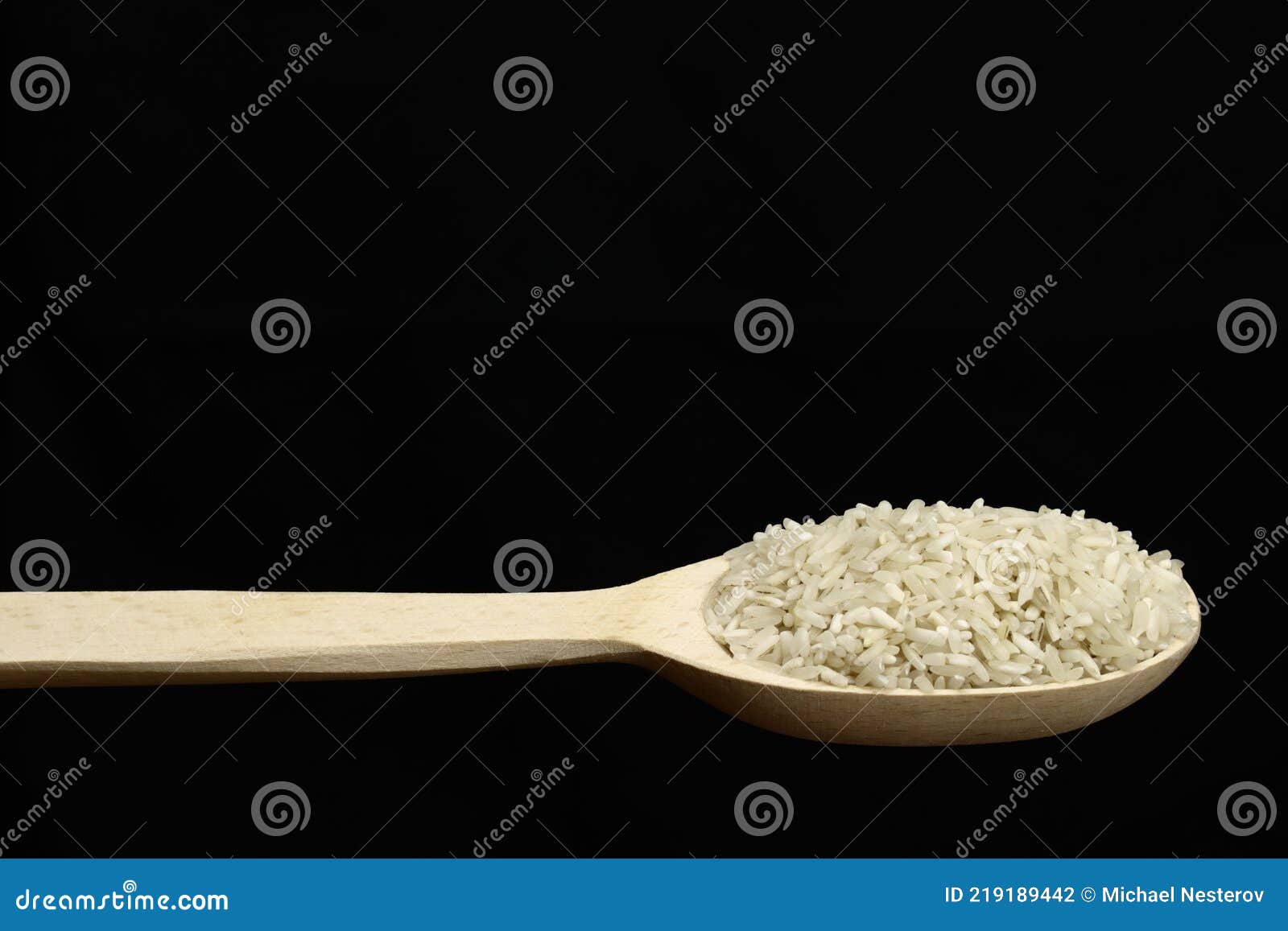 Raw Rice Grits in a Wooden Spoon on a Black Background Stock Photo ...
