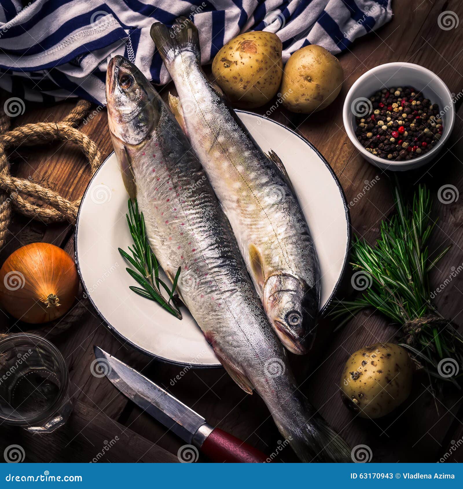 Raw River Fish with Potatoes,onion,spices and Herbs on a Wooden Table ...