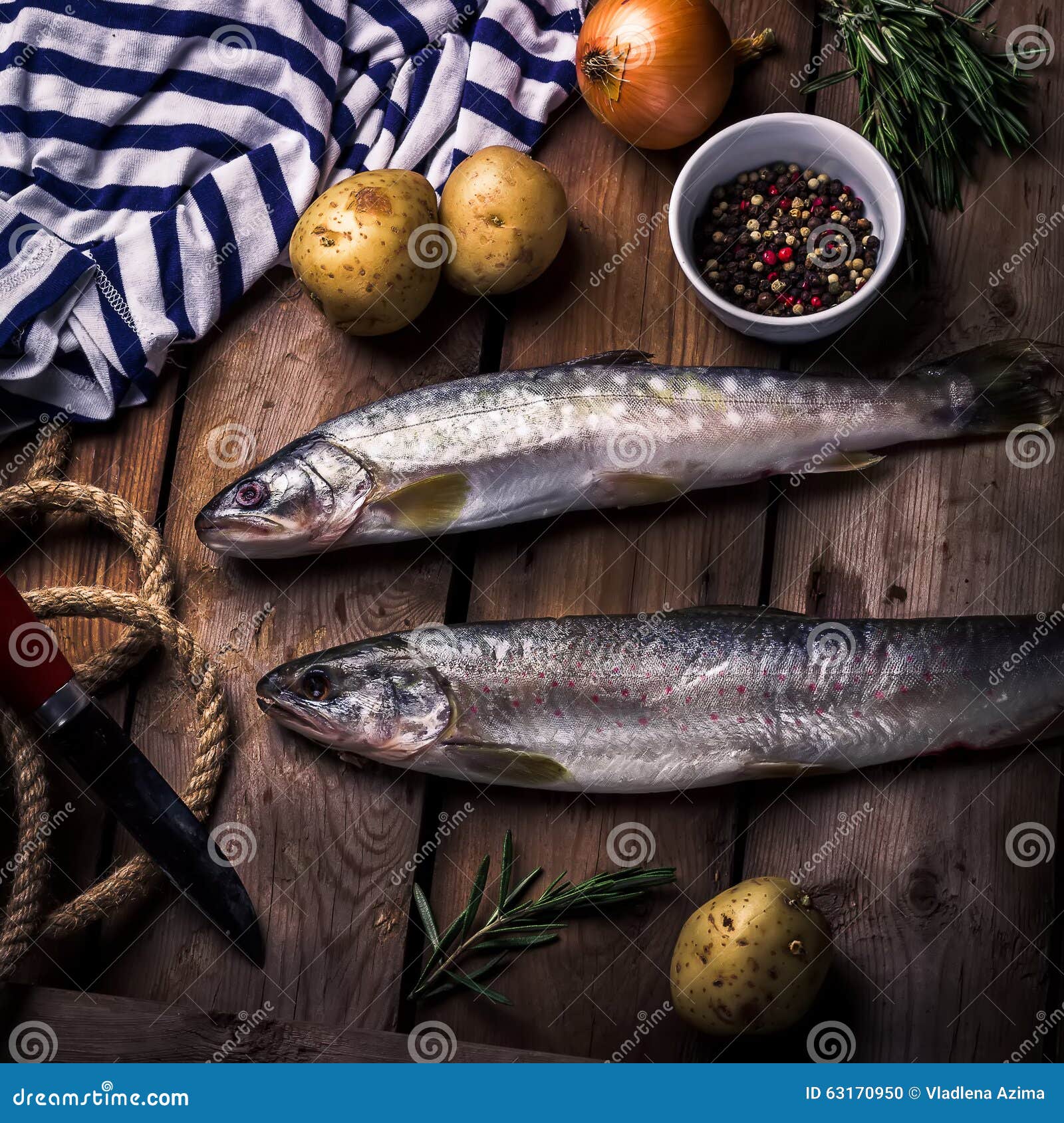 Raw River Fish with Potatoes,onion,spices and Herbs on a Wooden Table ...