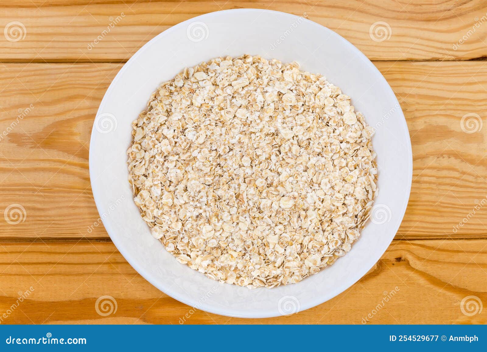 Raw Rolled Oats in Bowl on Rustic Table, Top View Stock Image - Image ...